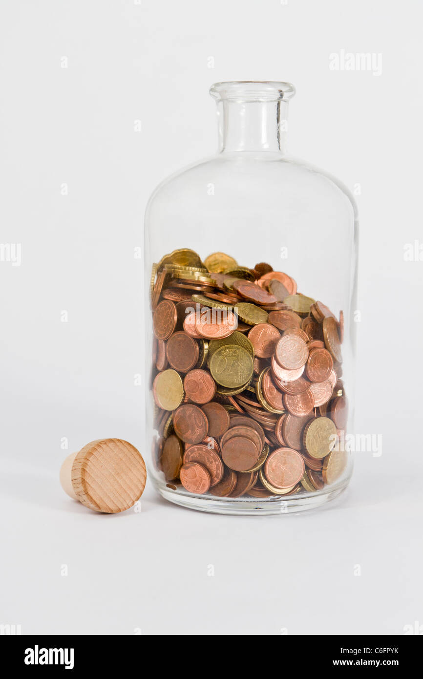 different coins in glass bottle Stock Photo - Alamy