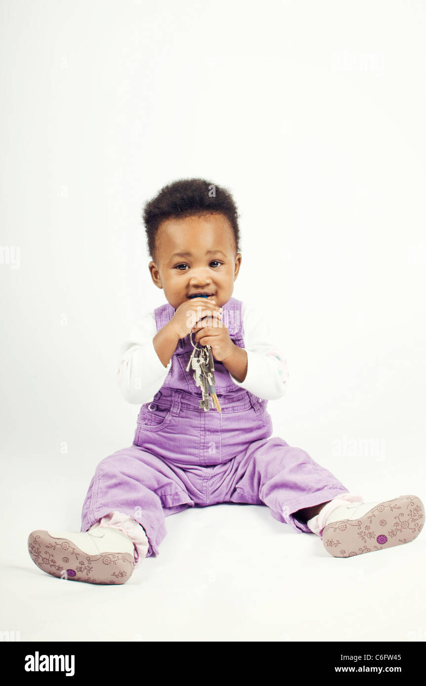A baby girl holding a bunch of keys Stock Photo - Alamy