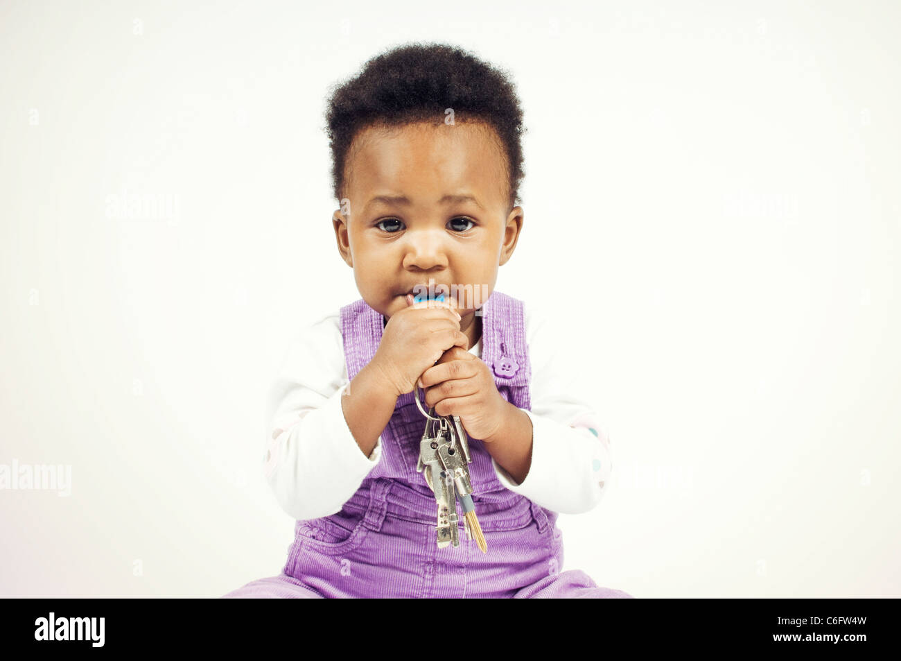 A baby girl holding a bunch of keys Stock Photo - Alamy