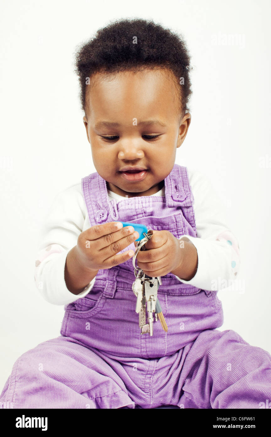 A baby girl looking at a bunch of keys Stock Photo - Alamy