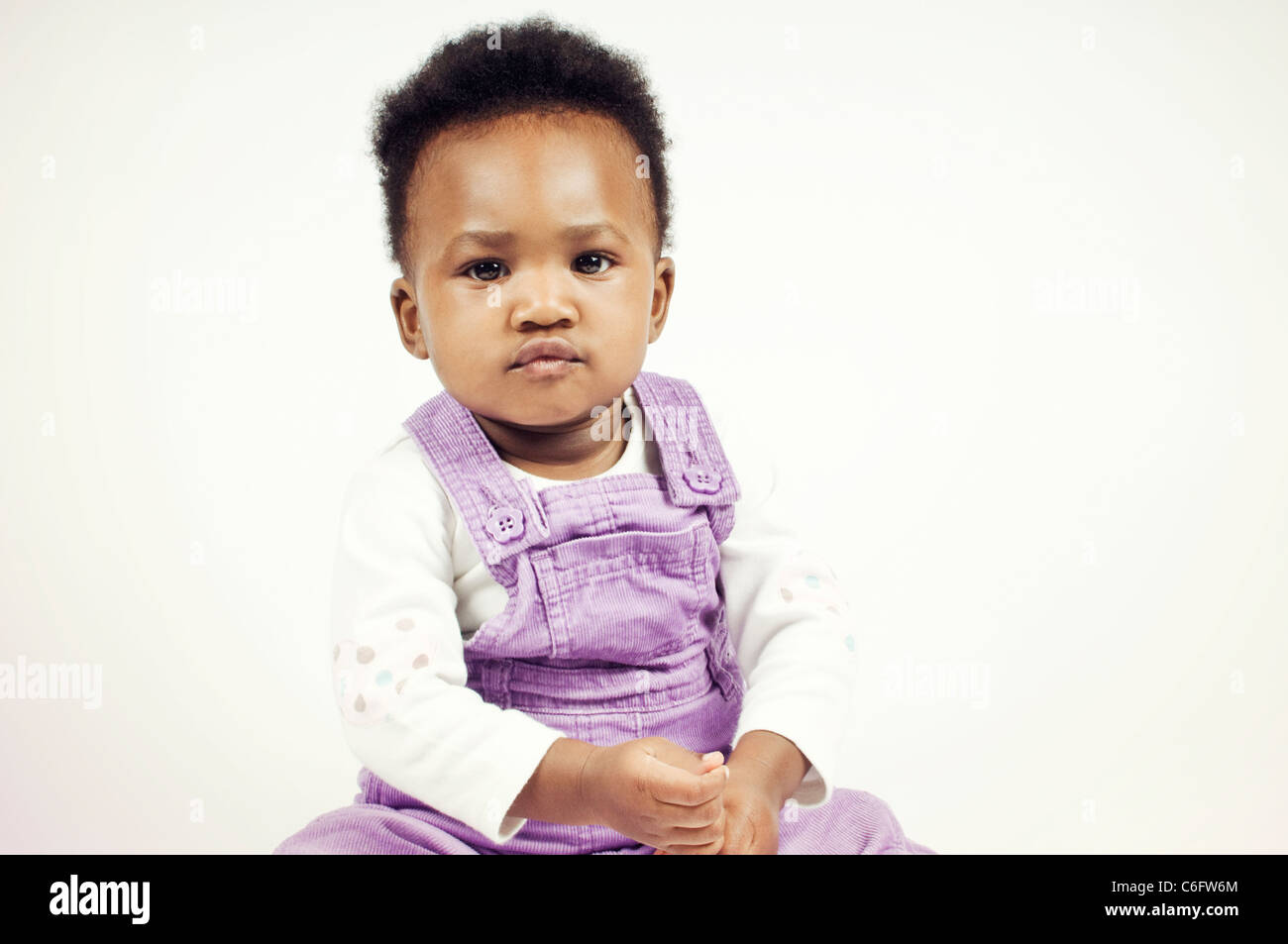 A portrait of a baby girl, looking serious Stock Photo - Alamy