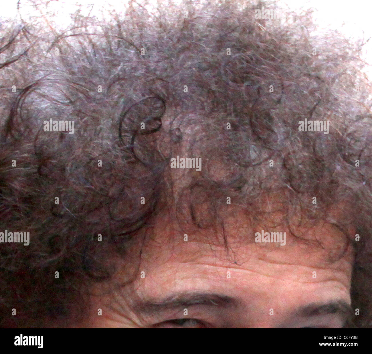 Queen guitarist Brian May shows signs of thinning hair from his famous ...