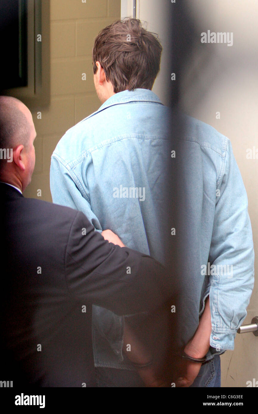 Escorted in handcuffs hi-res stock photography and images - Alamy