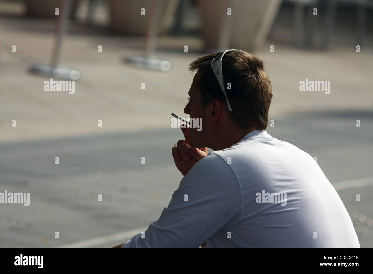 A profile view of a man smoking a cigarette Stock Photo - Alamy