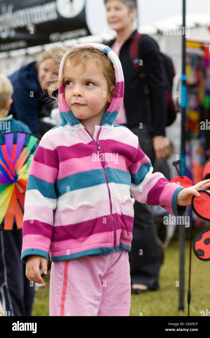 child fascinated with colourful wind toy at southsea kite festival ...