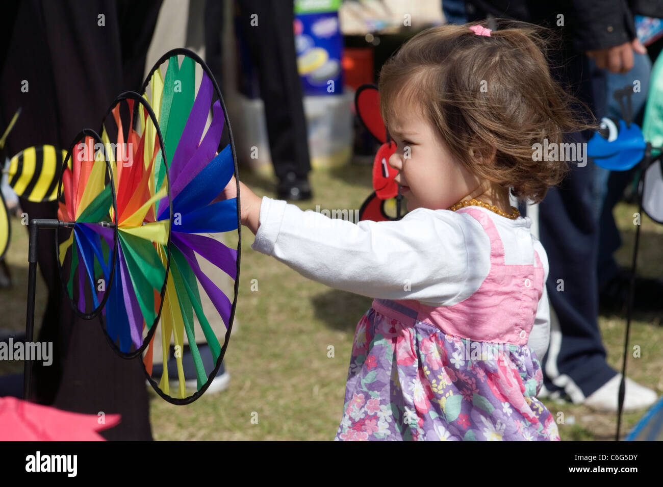 child fascinated with colourful wind toy at southsea kite festival ...