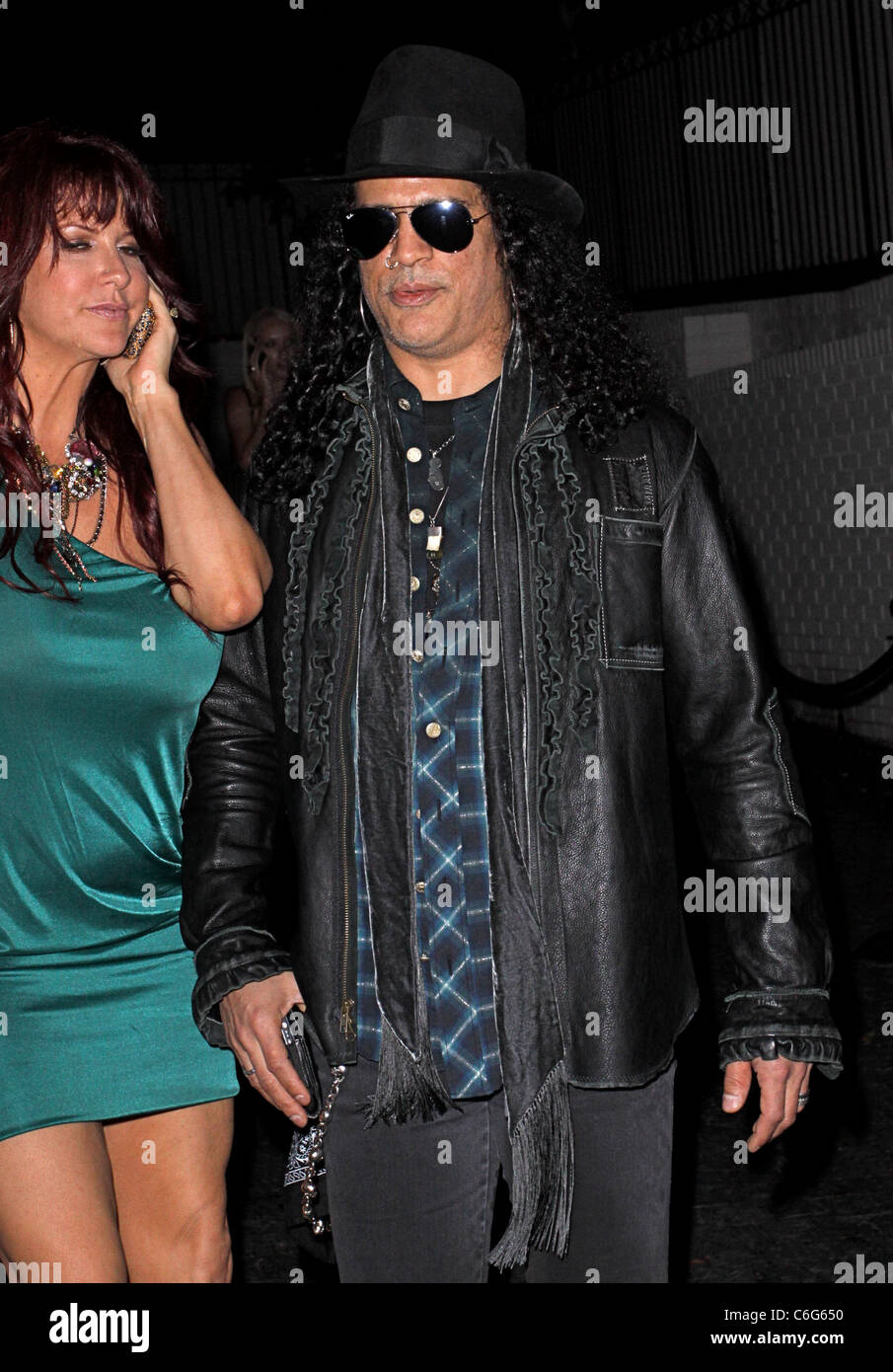 Slash and wife Perla Hudson arriving at pre-Oscars party at Chateau ...