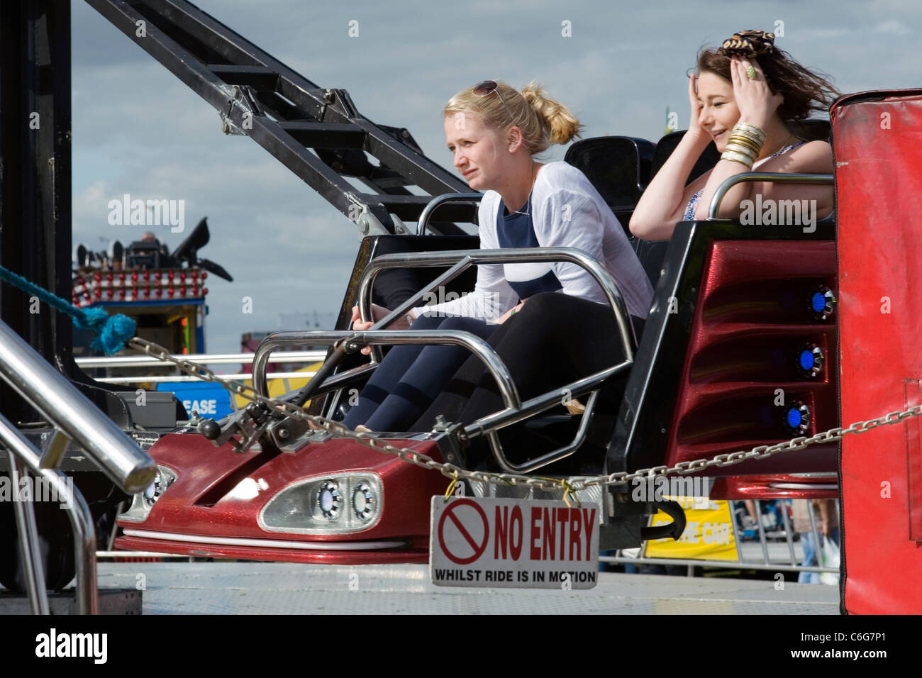 two young women enjoying a fairground ride Stock Photo - Alamy