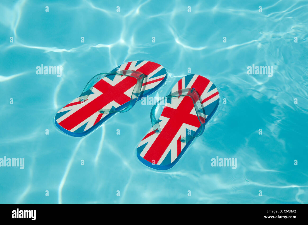 union jack flip flops floating in swimming pool Stock Photo - Alamy