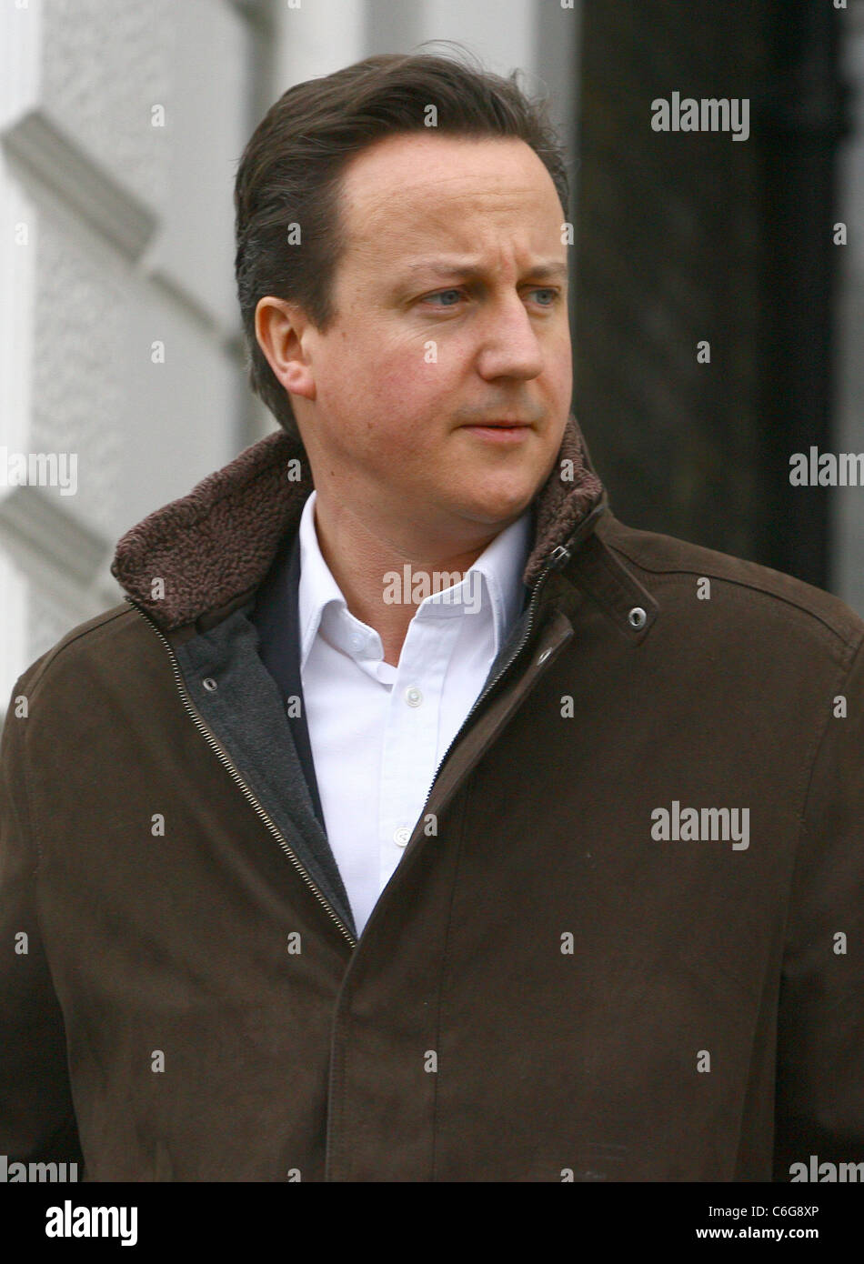 David Cameron makes his way home after taking his children to school ...