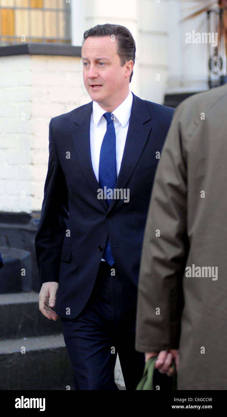 David Cameron makes his way home after taking his children to school ...