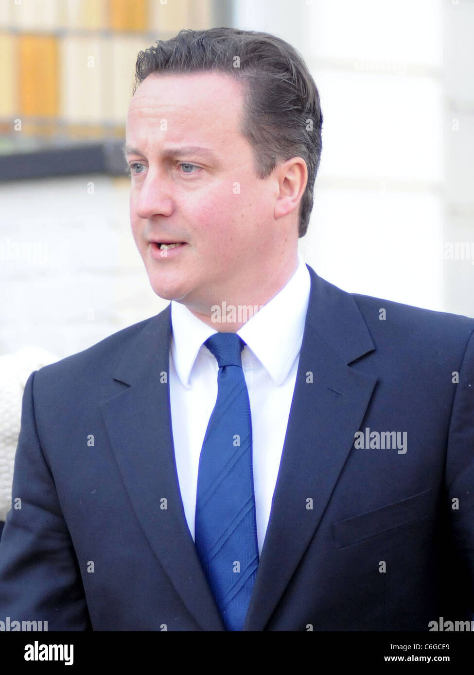 David Cameron makes his way home after taking his children to school ...