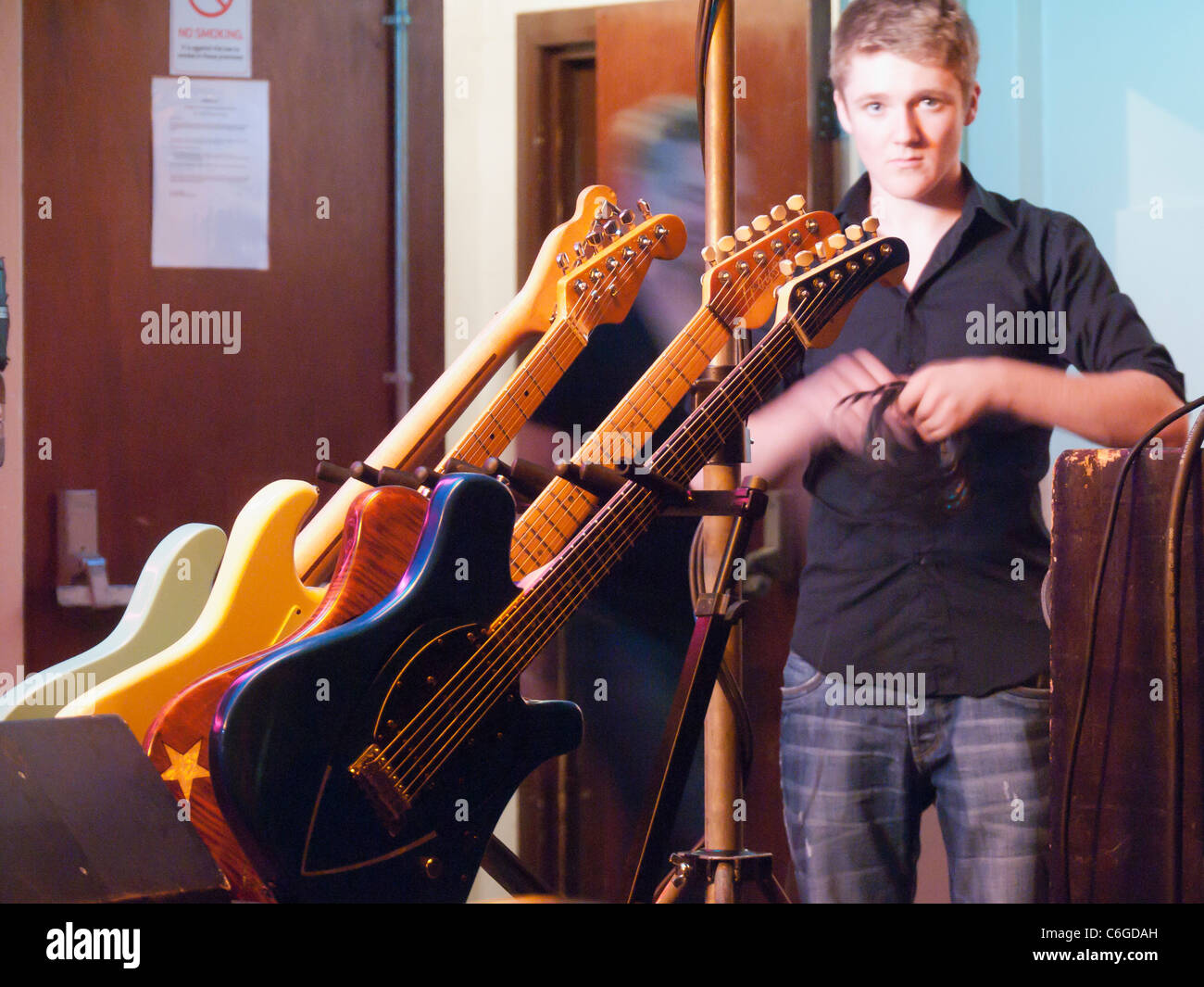 Musicians prepare equipment and guitars for gig Stock Photo - Alamy