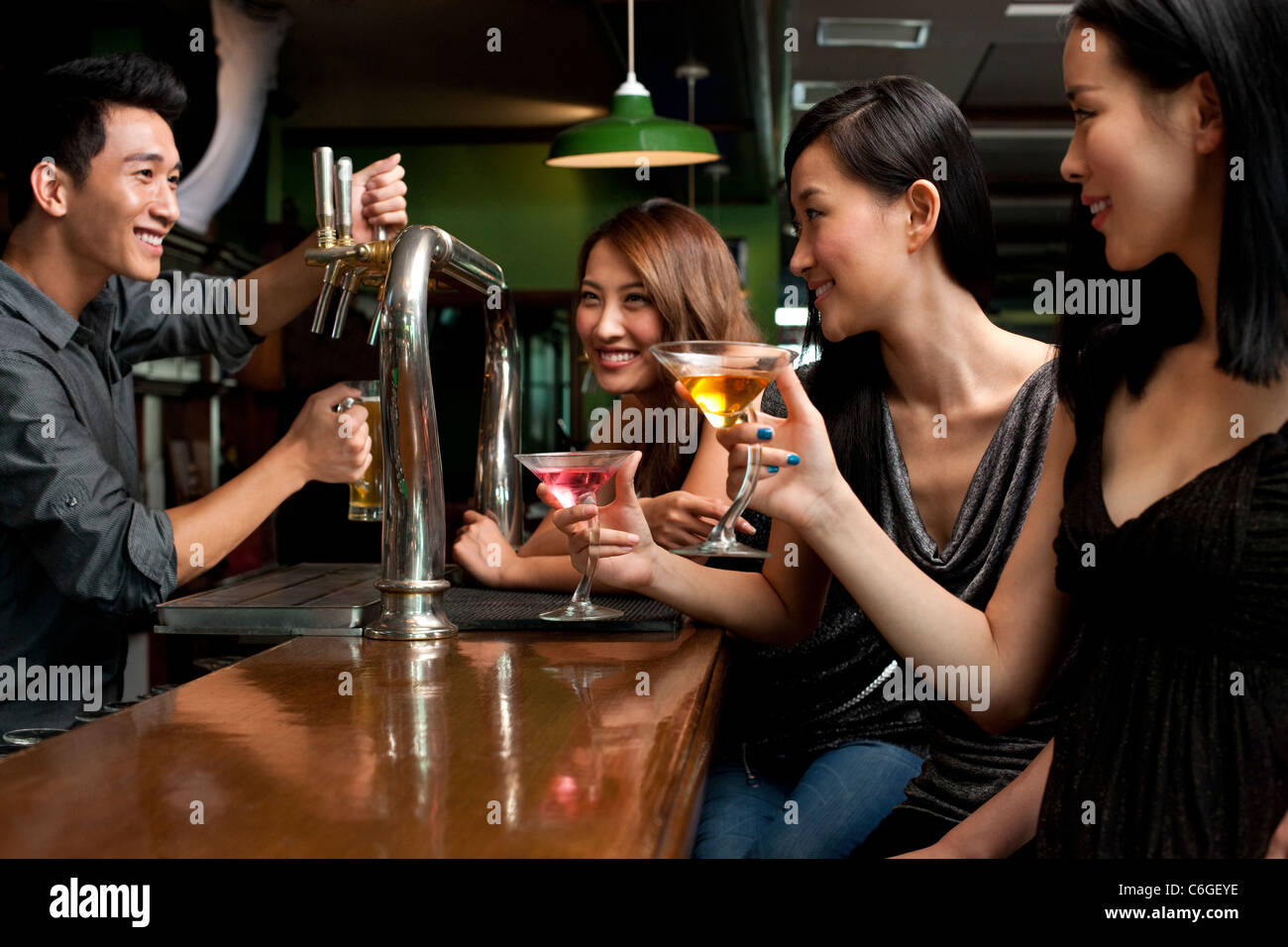 Bartender Serving Drinks Stock Photo - Alamy