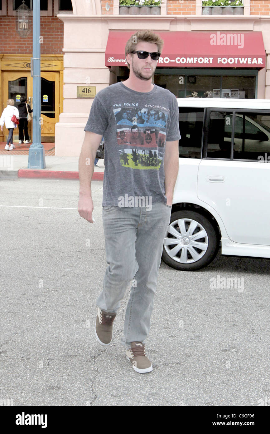 Liam Hemsworth sucking on a lollipop while walking in Beverly Hills ...
