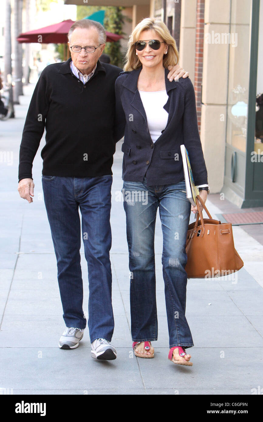 Larry King and Shawn Southwick walking arm-in-arm and looking happy ...