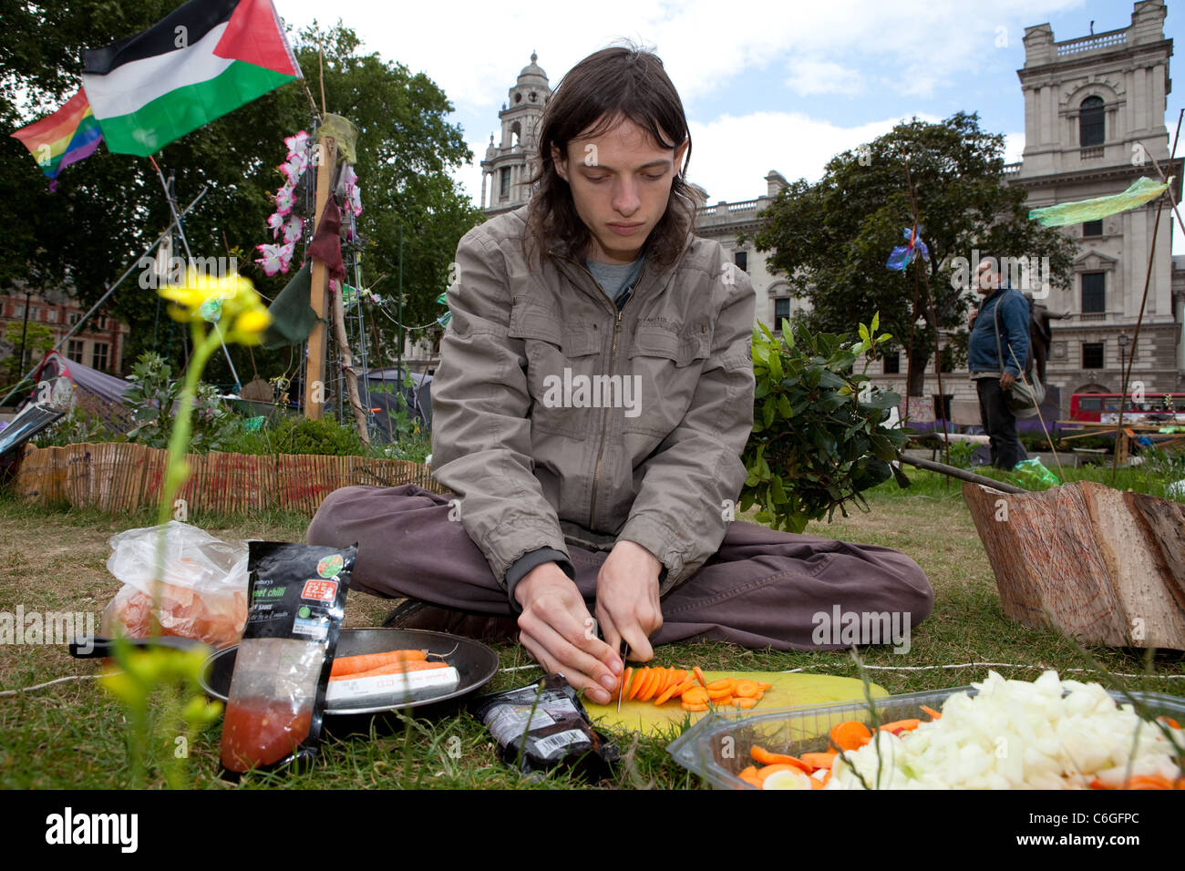 Johnathan Lamb, 24, prepares a communal meal at Democracy Village Stock ...