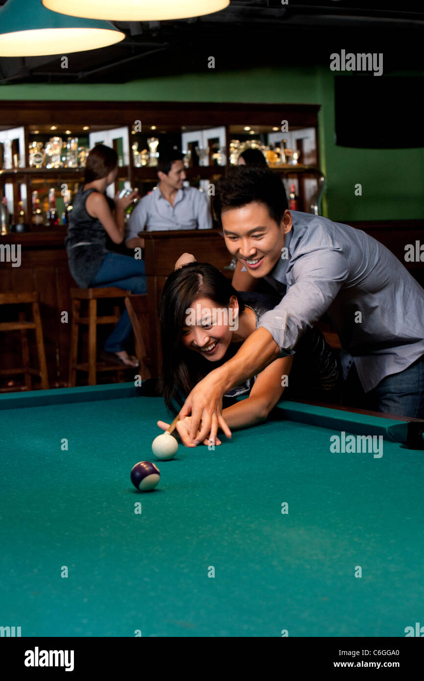 Men Standing Around Pool Table High Resolution Stock Photography and ...