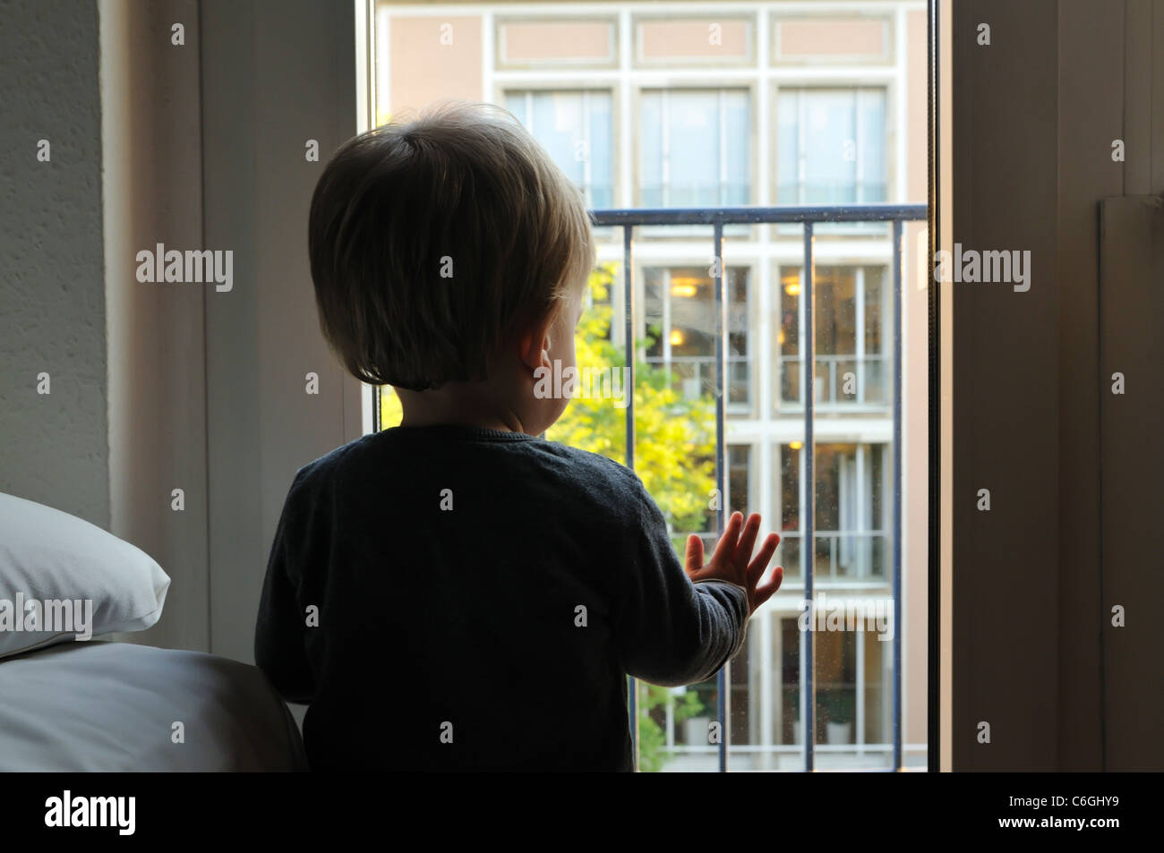 Boy and window Stock Photo - Alamy