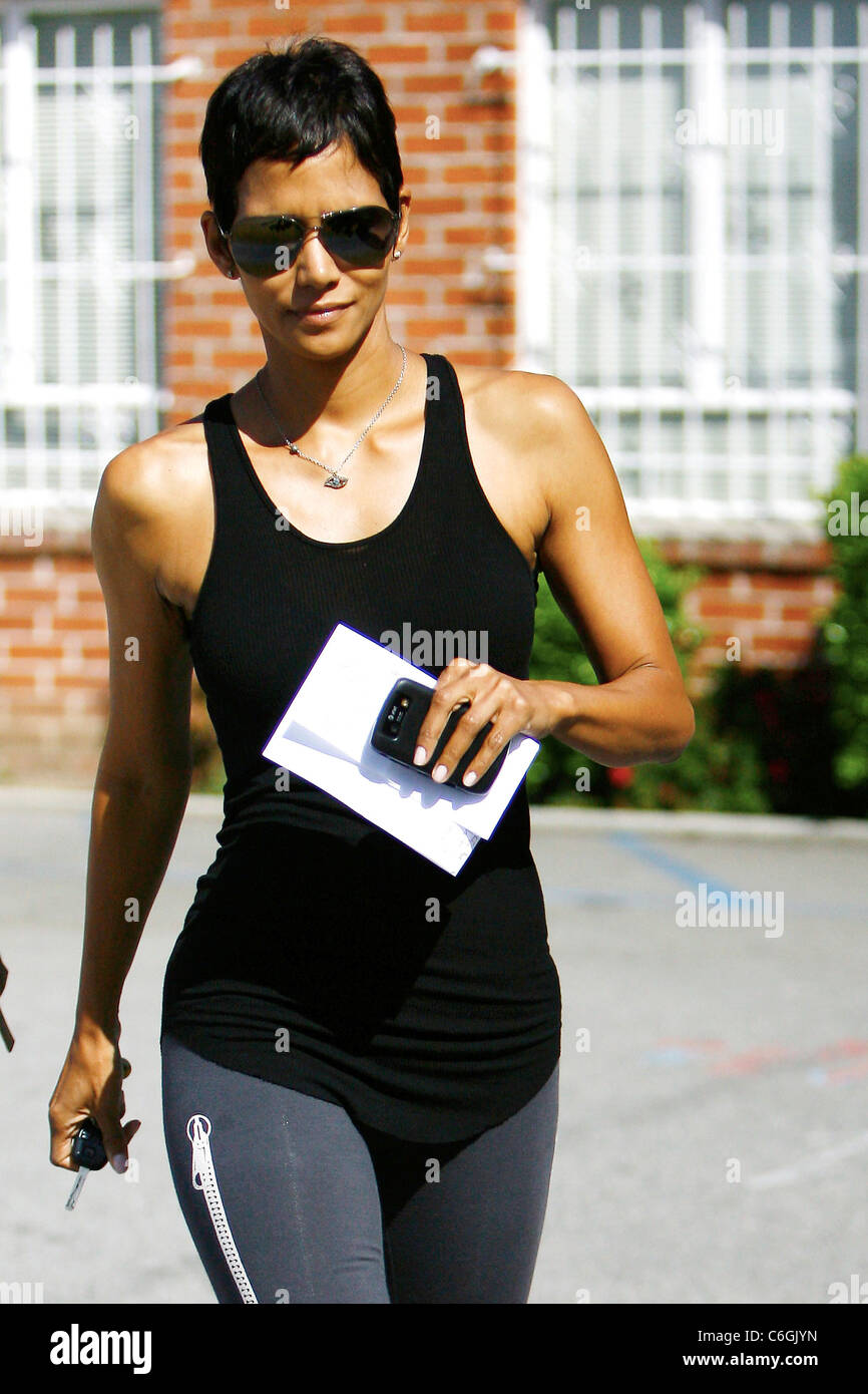 Halle Berry going to an office building with a friend. Halle is ...