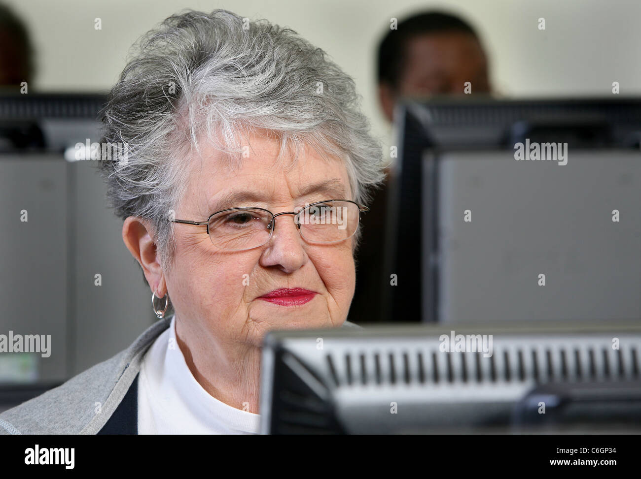 A senior citizen learns how to use the computer and Internet Stock ...