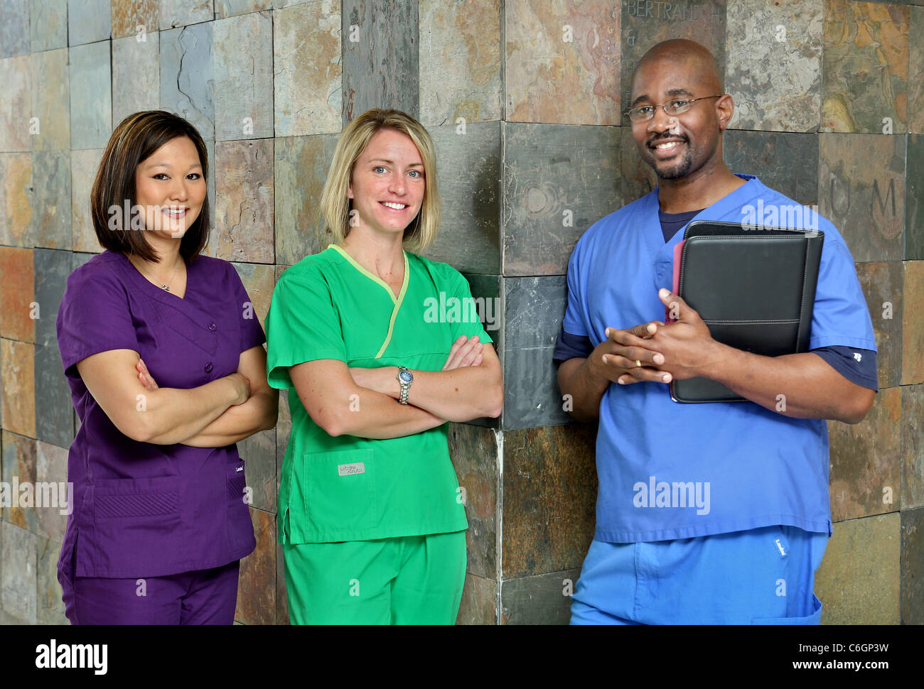 Nurses pose by a wall in a hospital Stock Photo - Alamy