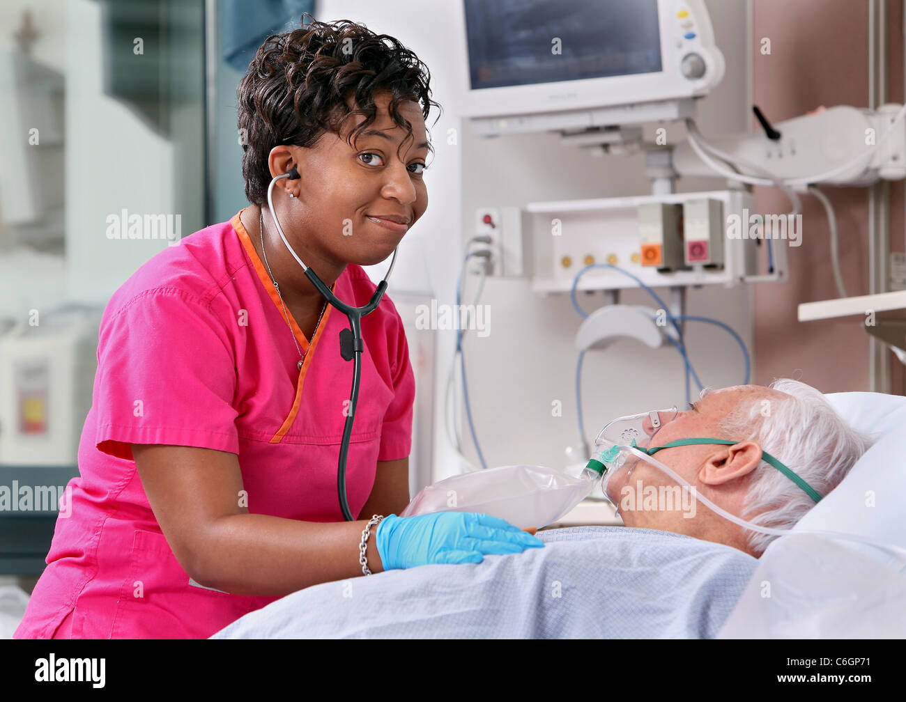 A nurse works with a patient in a hospital room Stock Photo - Alamy
