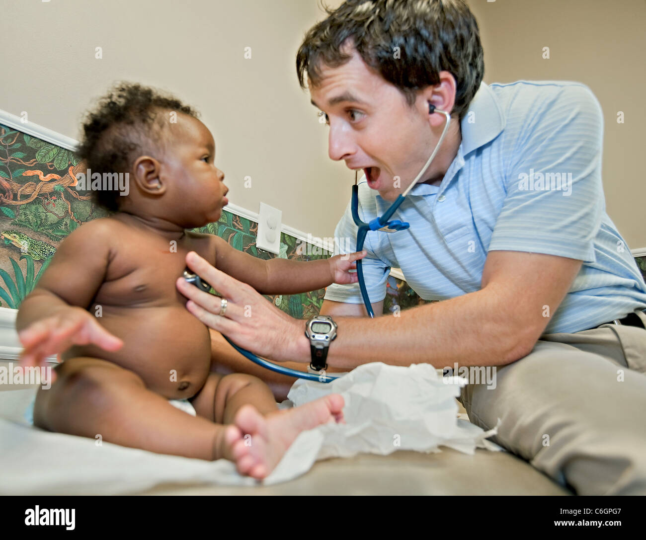 A pediatric doctor examines a baby during a checkup Stock Photo - Alamy