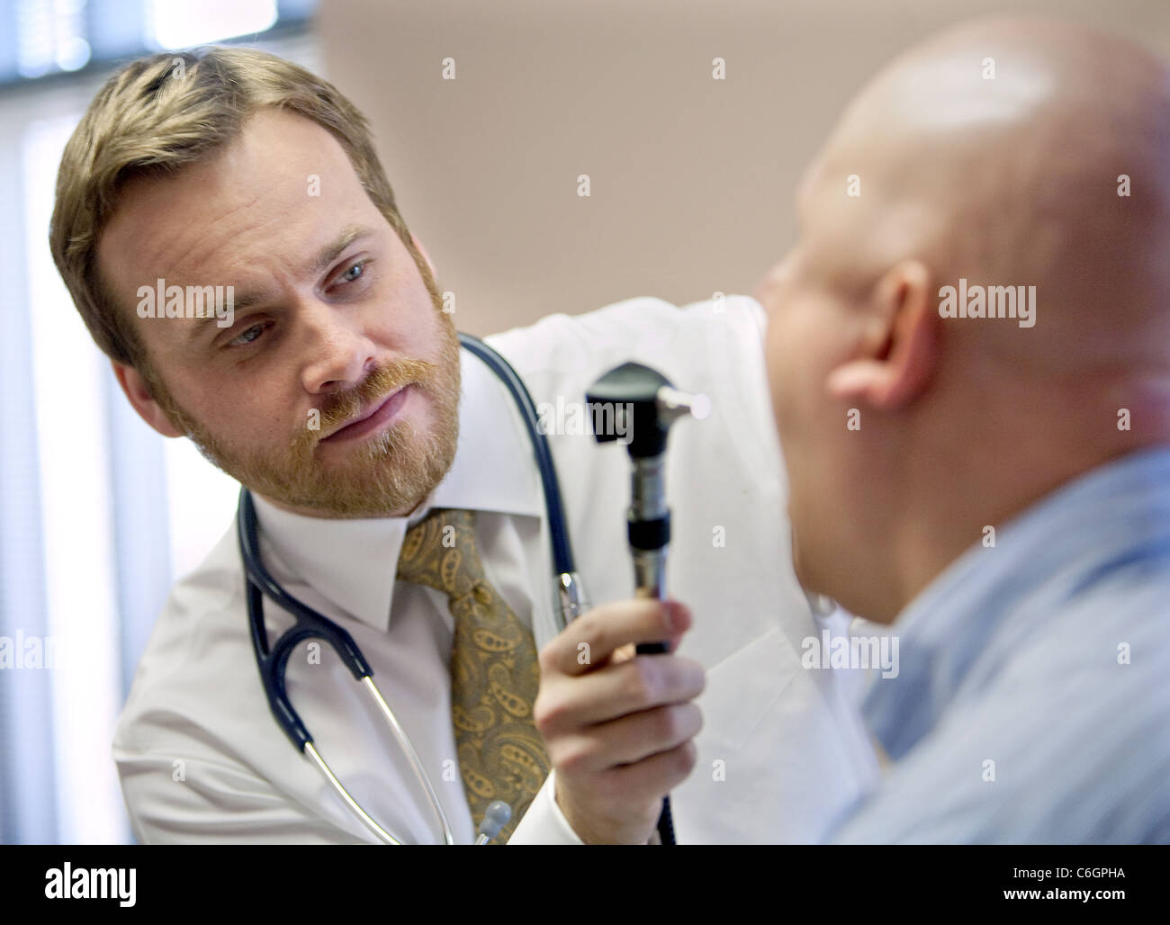 A doctor examines a patient in his examine room Stock Photo - Alamy