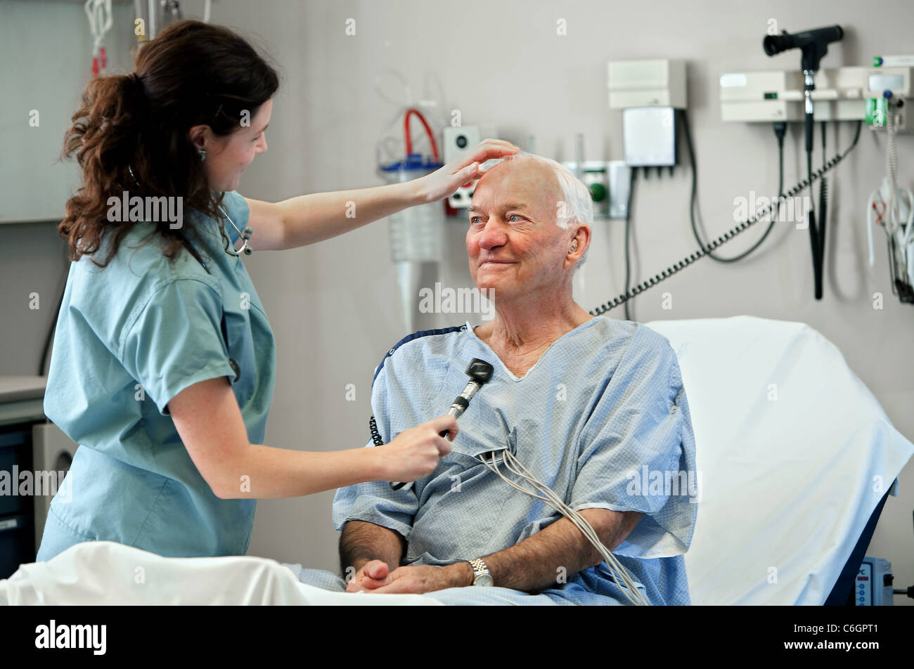 A nurse checks on a patient in a hospital Stock Photo - Alamy