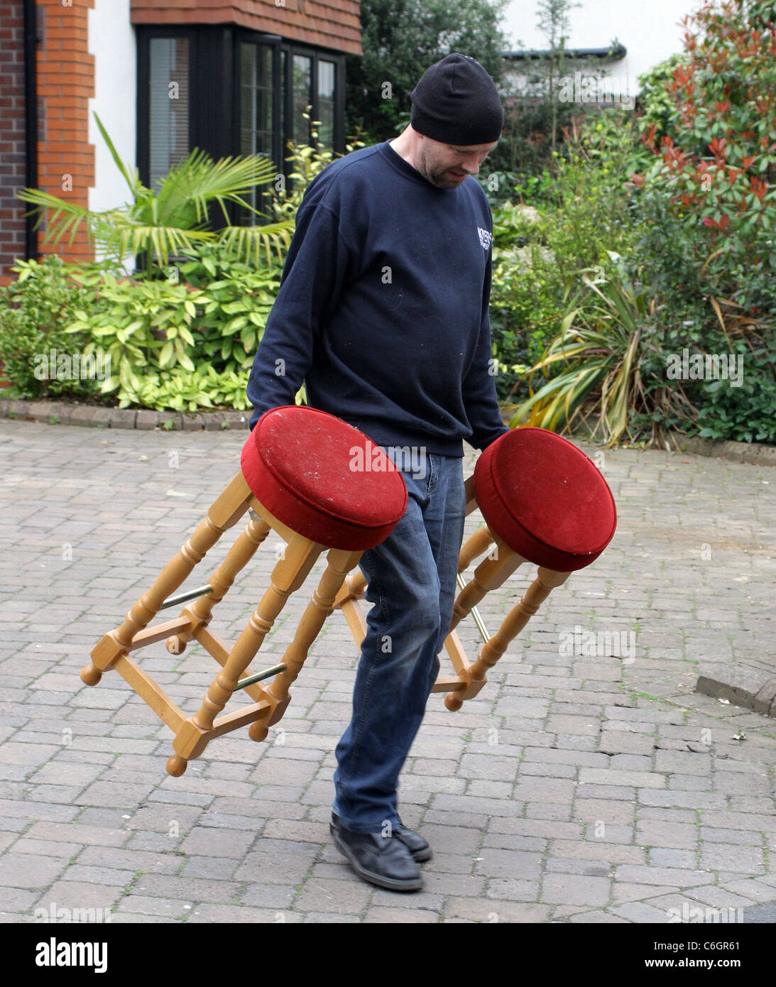 Removal men move dirty bar stools from Kerry Katona's house on to a ...