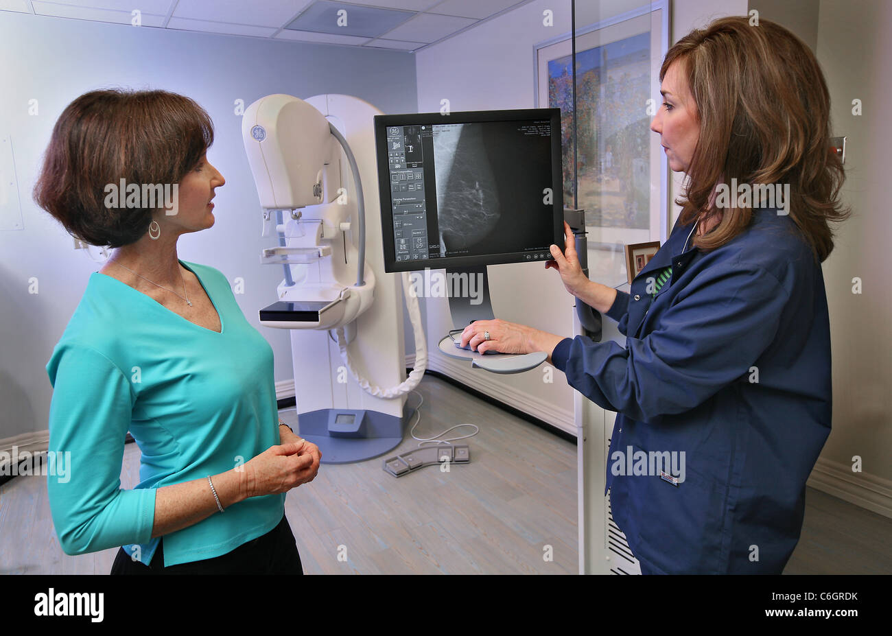 Patient and nurse at mammogram machine Stock Photo - Alamy