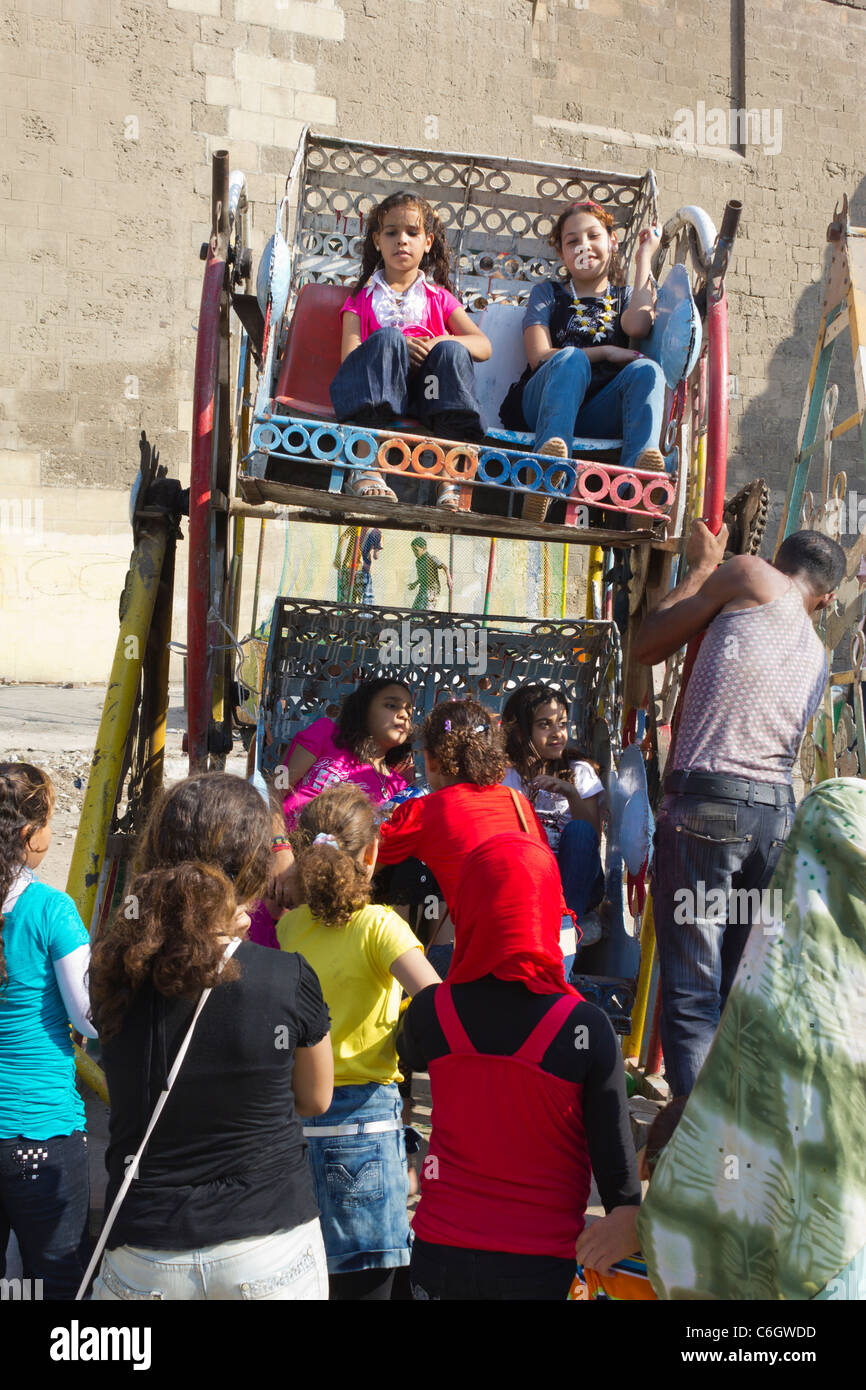 children on fairground ride for celebration of the Eid al-Fitr, marking ...