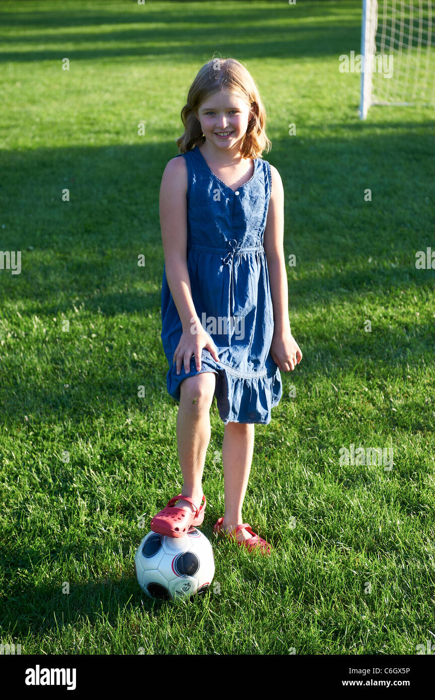 Child girl playing football (soccer) on field Stock Photo - Alamy