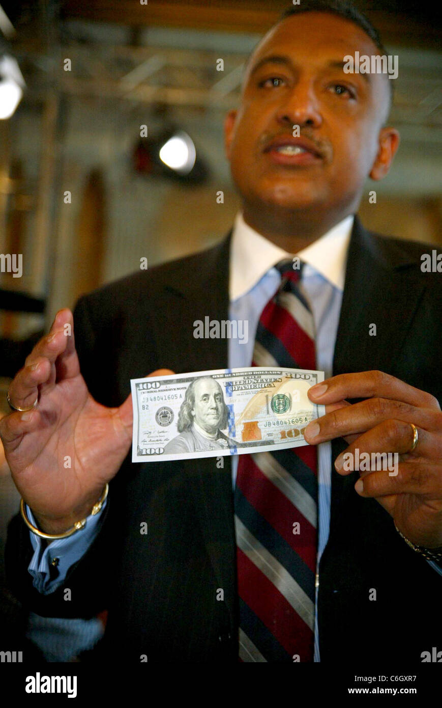 Larry R. Felix, Director of Bureau of Engraving and Printing, holding ...