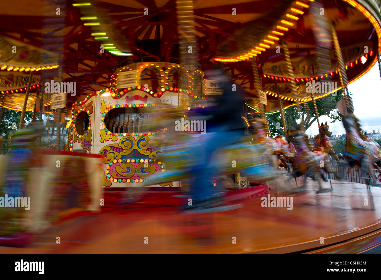 An illuminated carousel photographed at a slow speed to capture the ...
