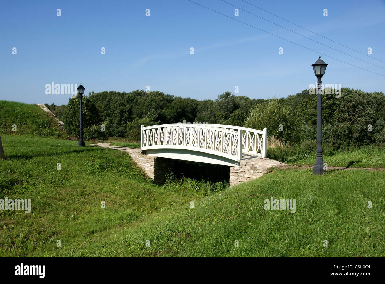 The white bridge on a background of a green grass and the sky Stock ...