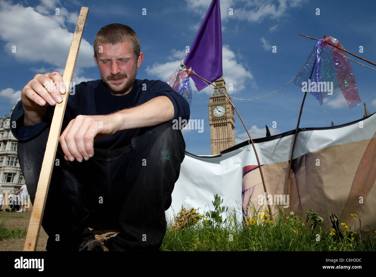 Activist Simon Moore at Democracy Village. He sits in the peace garden ...