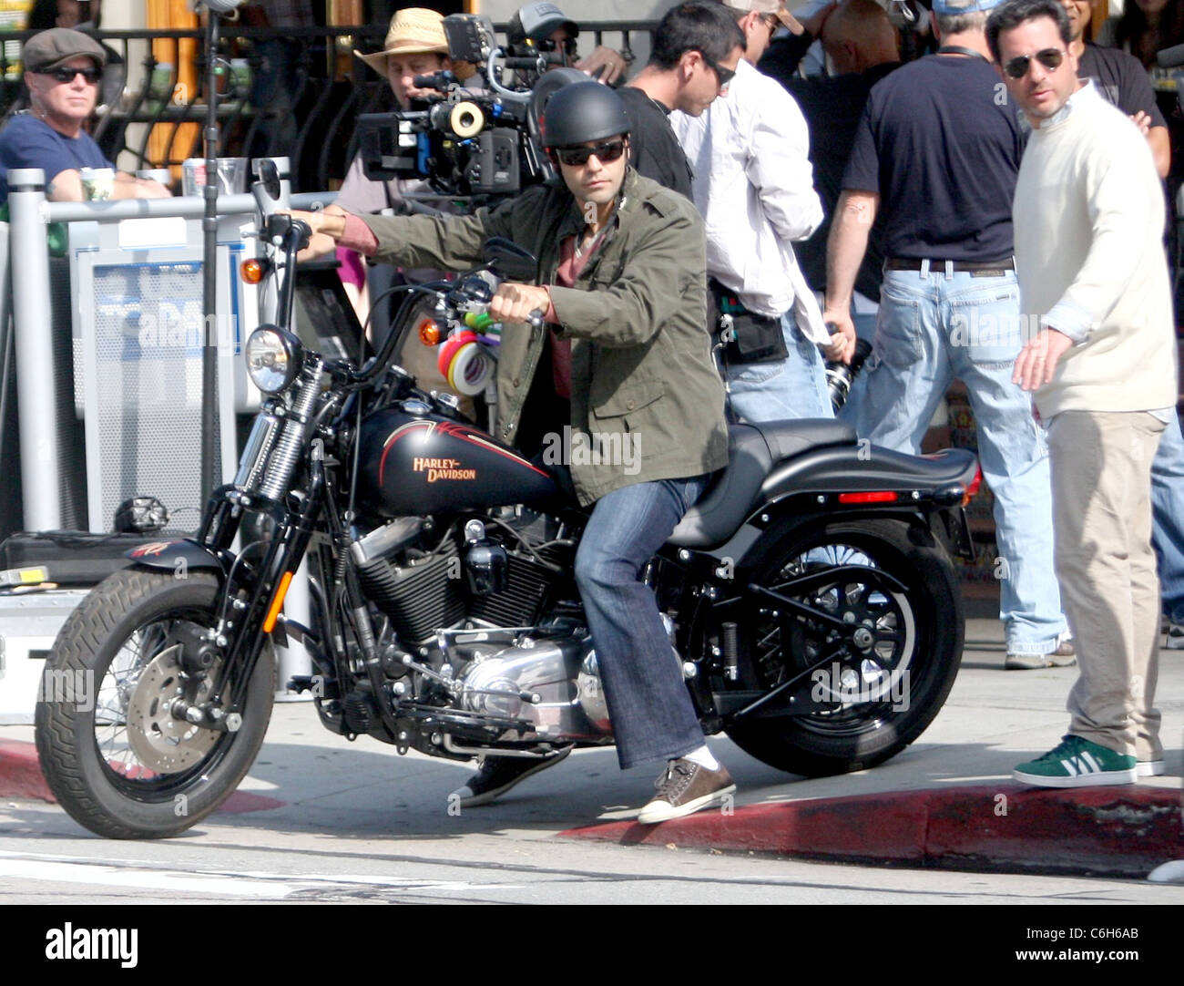 Adrian Grenier riding a Harley-Davidson motorcycle during a scene Cast ...