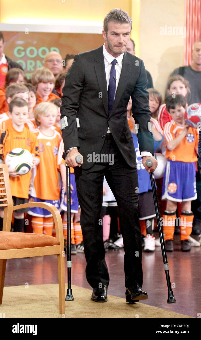 David Beckham standing up with the aid of crutches during his interview ...