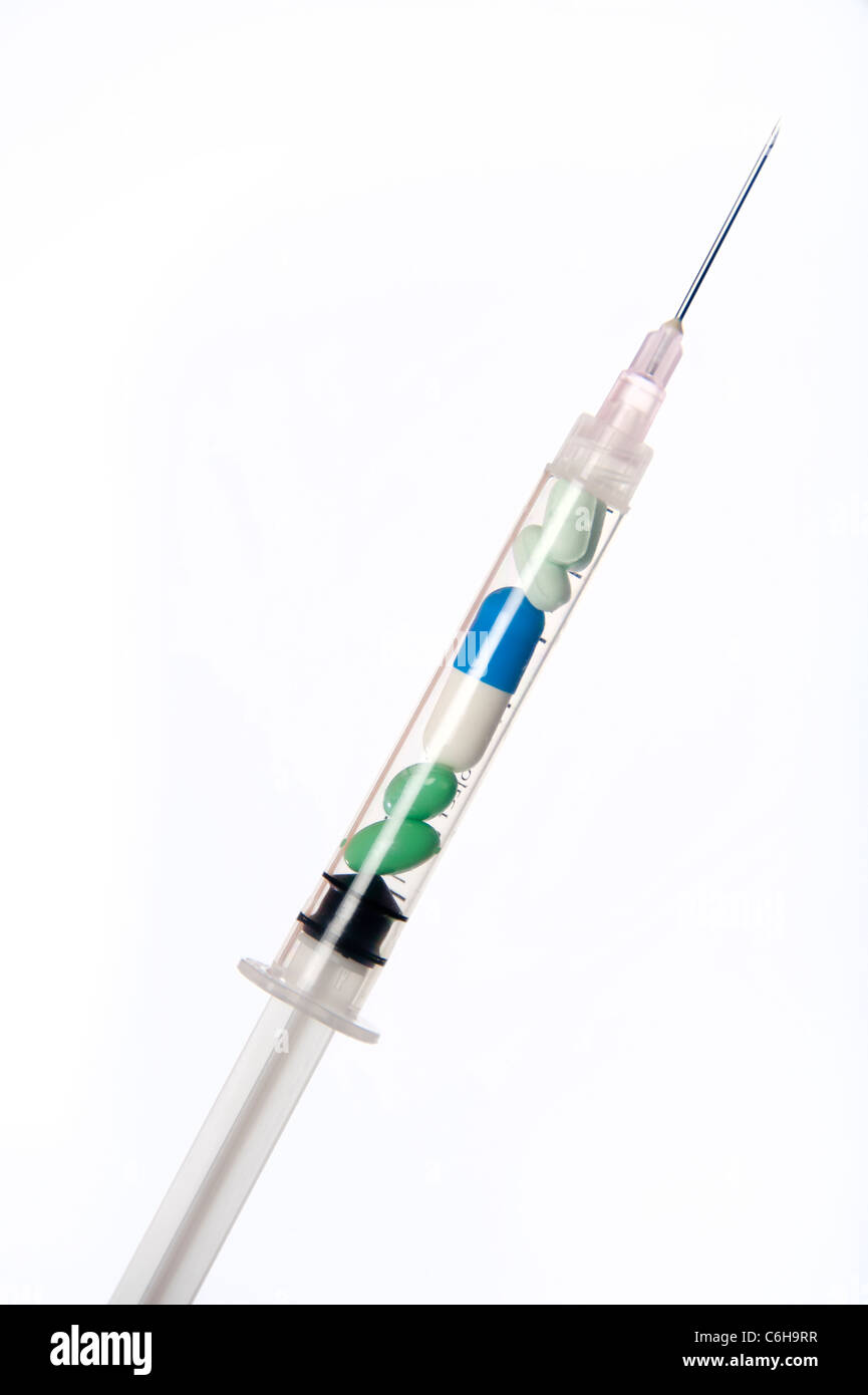 Syringe filled with tablets Stock Photo - Alamy
