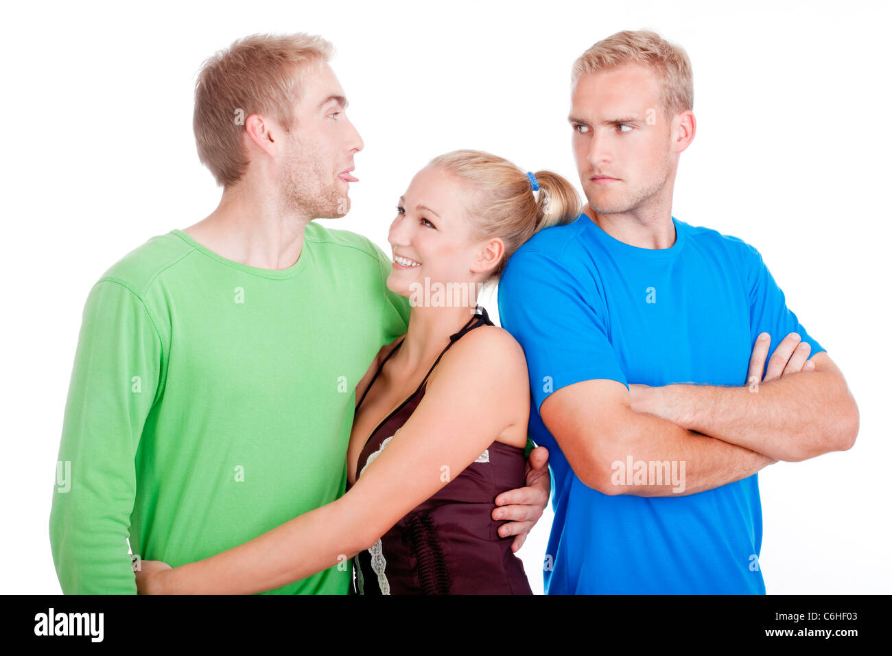 man with a girlfriend sticking out tongue to his jealous brother ...