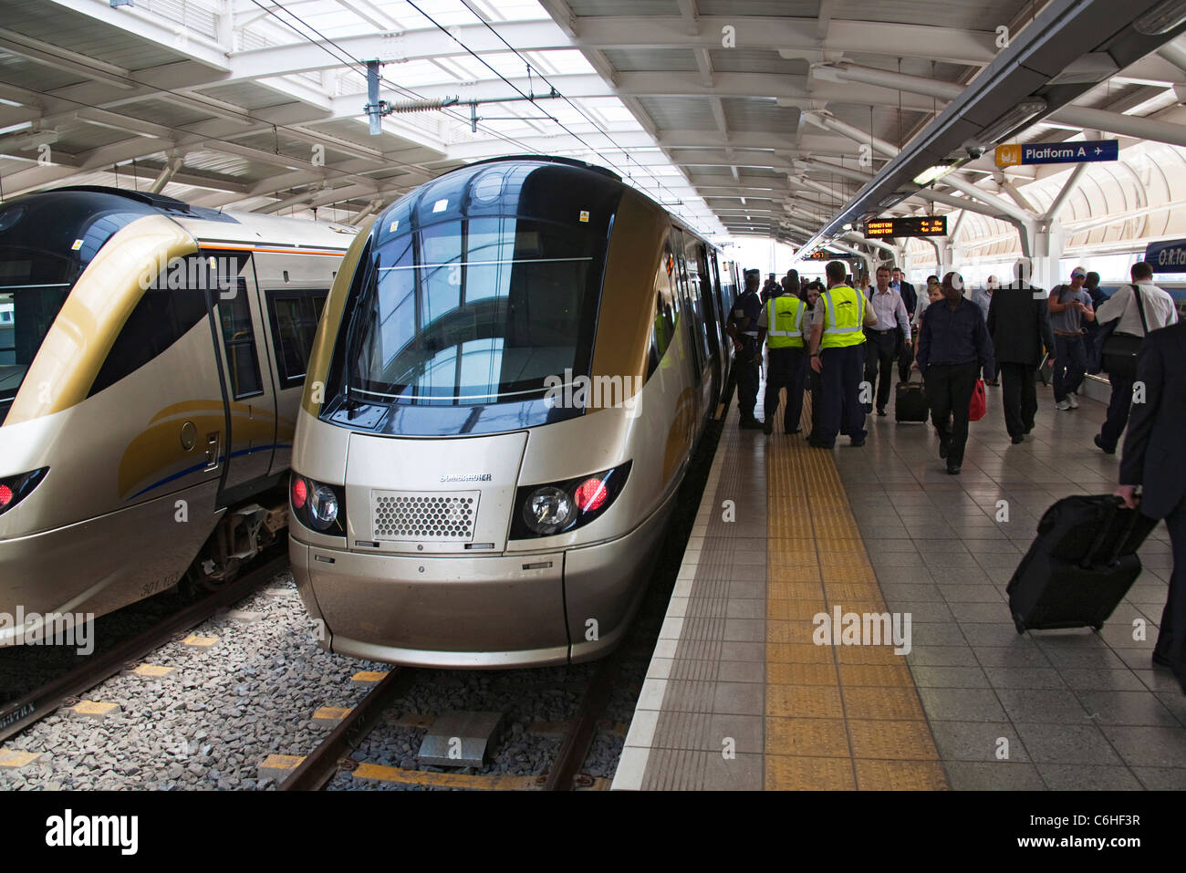 Commuters disembarking from the Gautrain at OR Tambo airport station ...