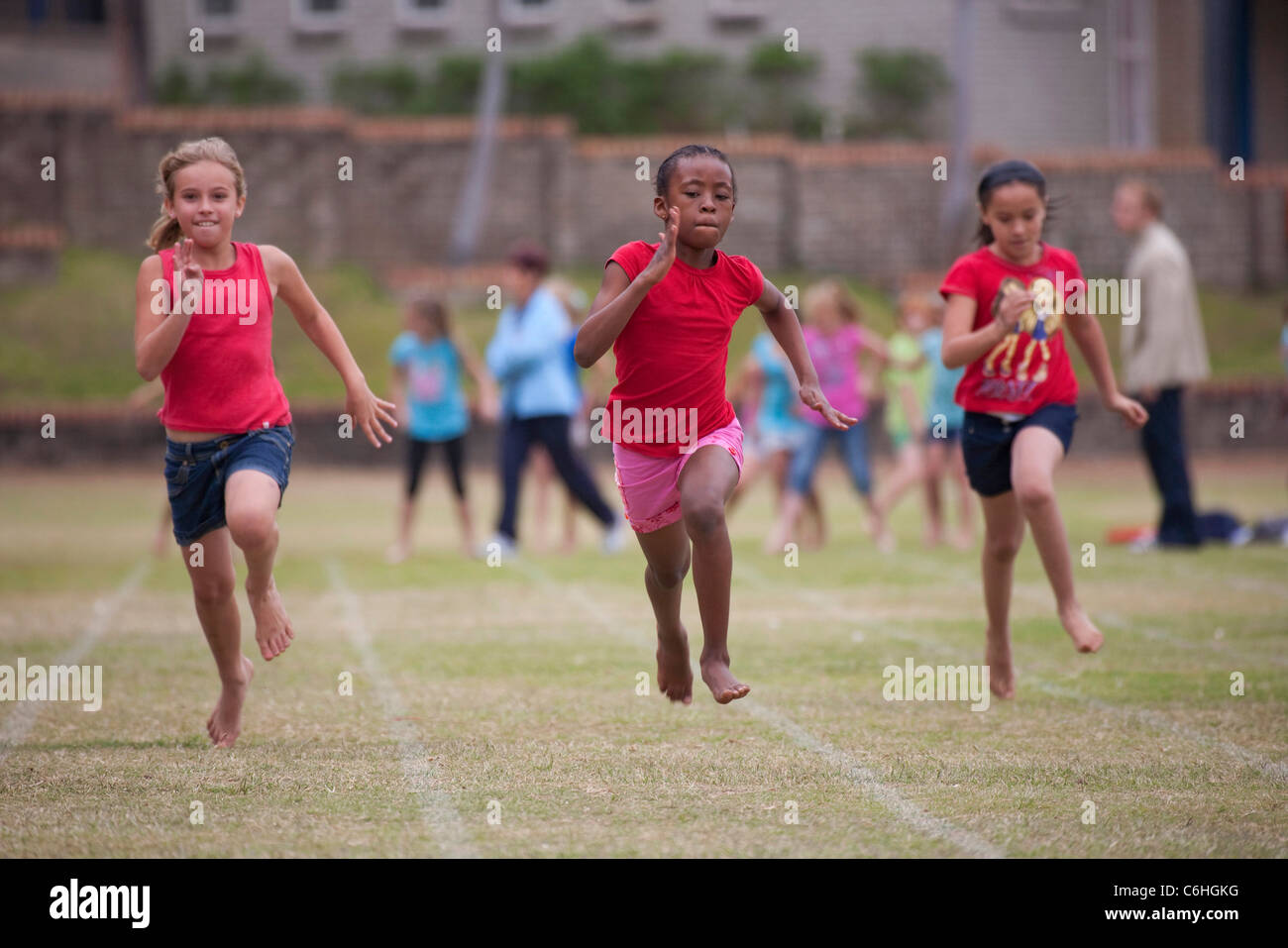 Primary school children running in inter-house athletics race Stock ...