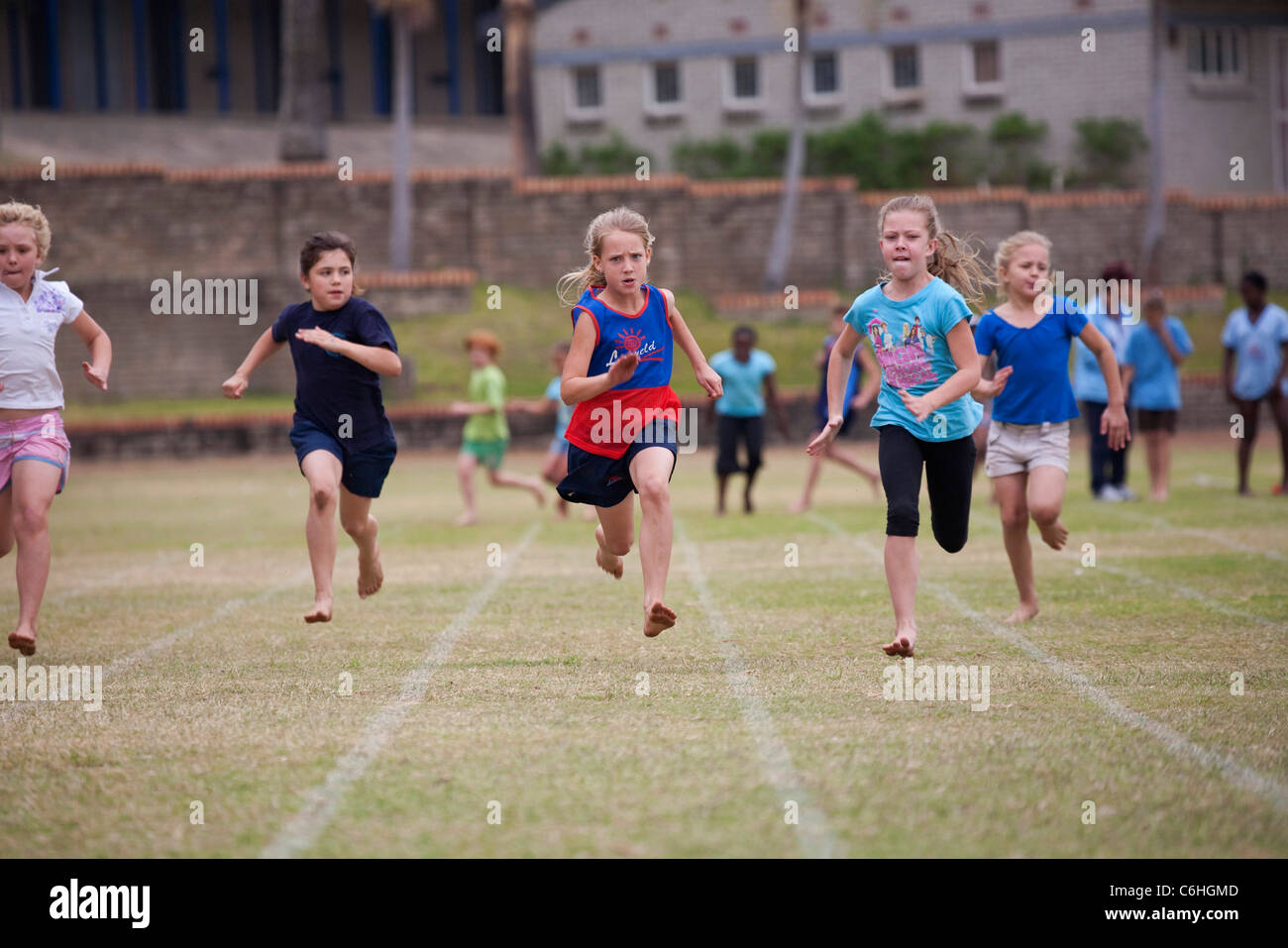 Primary school children running in inter-house athletics race Stock ...