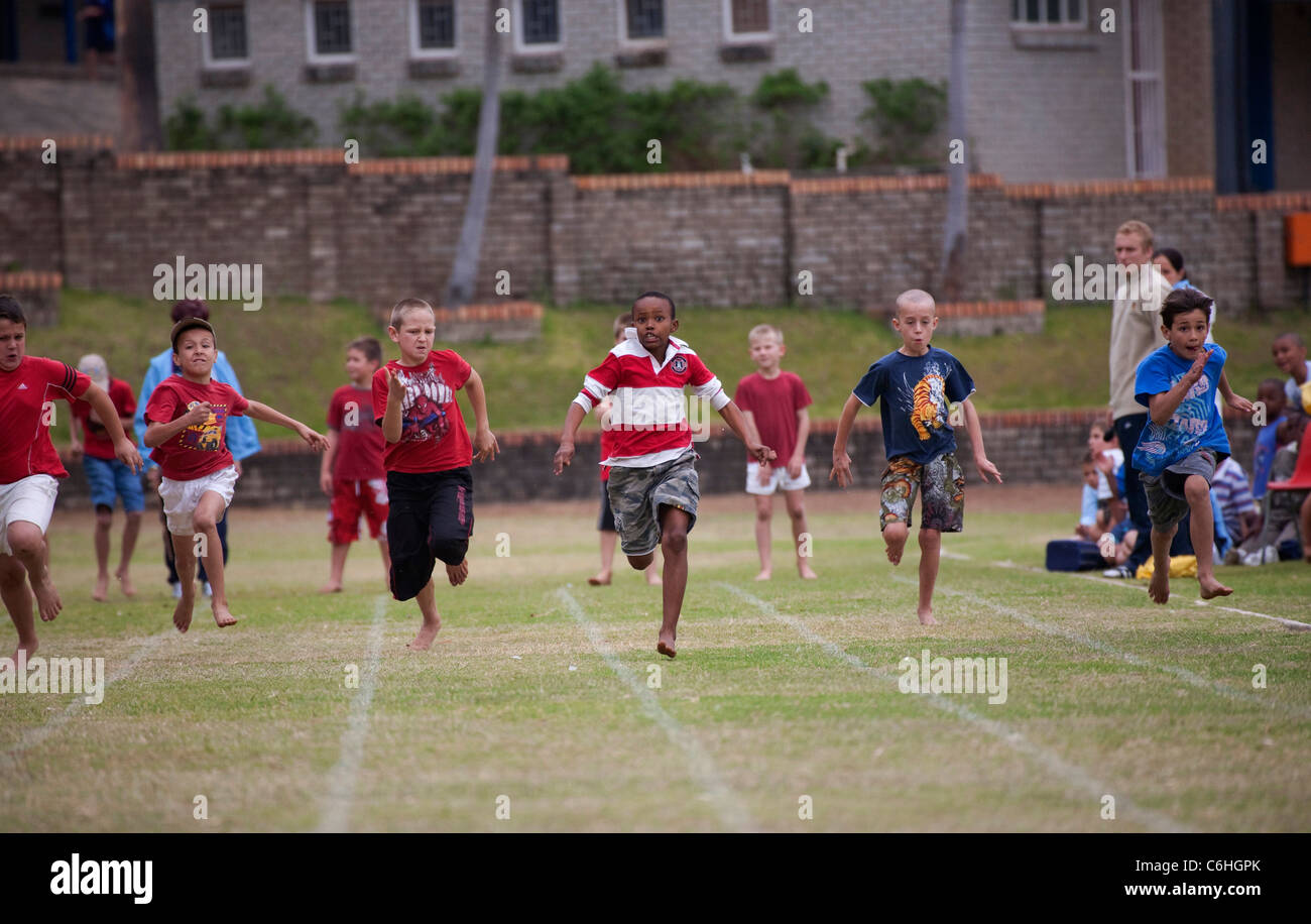 Primary school children running in inter-house athletics race Stock ...