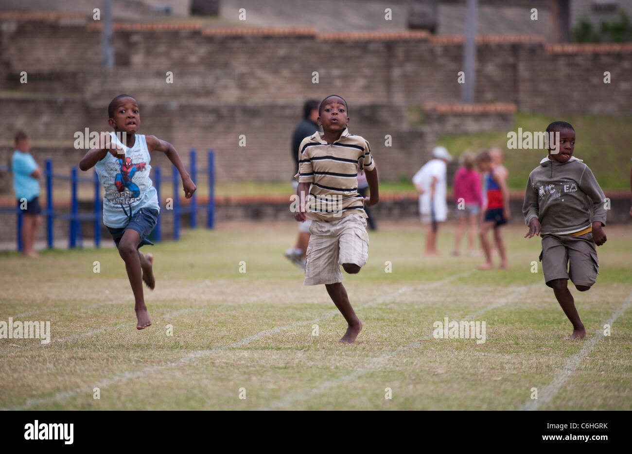 Primary school children running in inter-house athletics race Stock ...