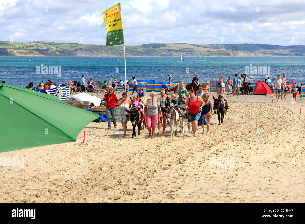 Traditional English seaside Donkey rides on the beach at Weymouth ...