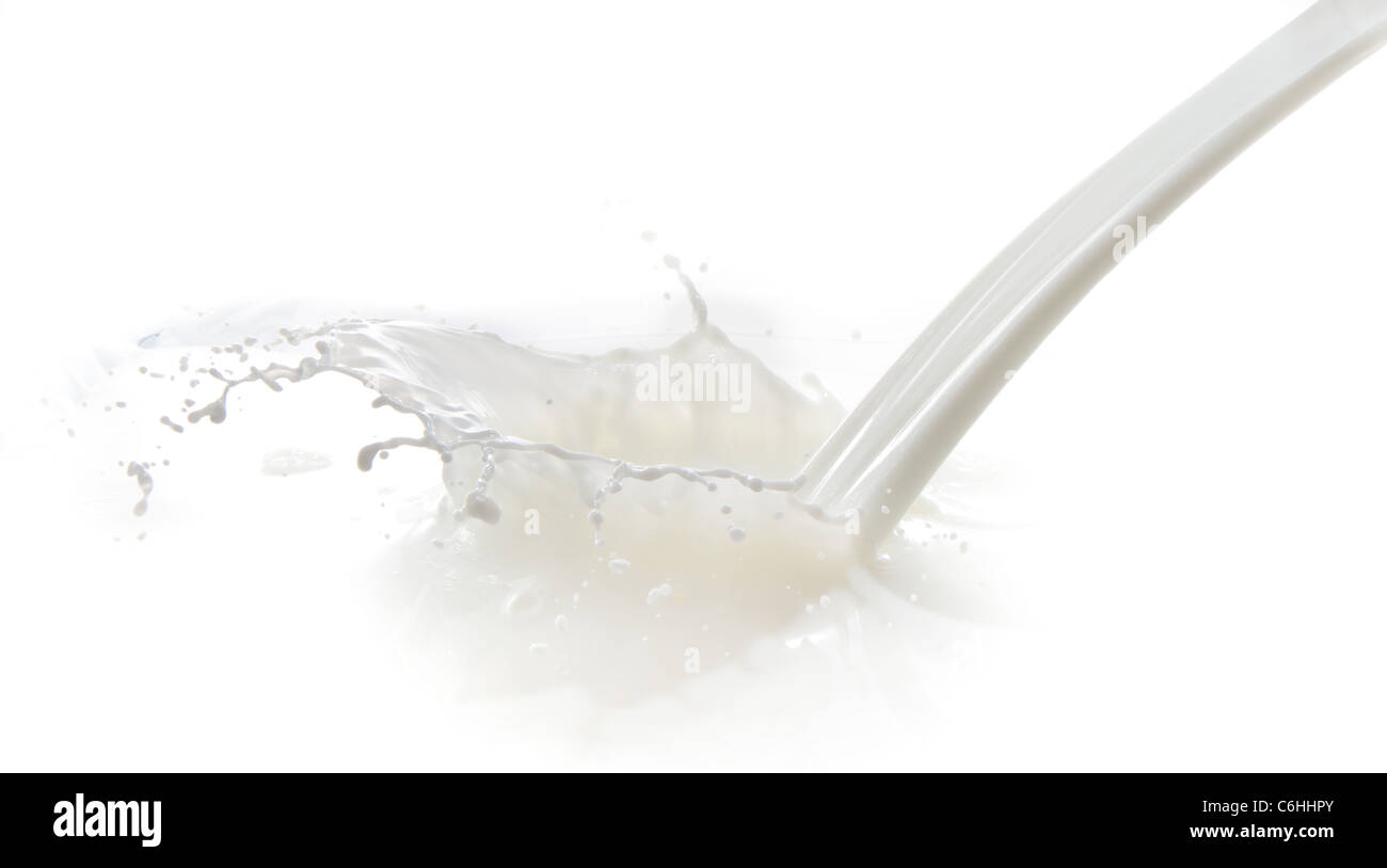 pouring milk splash isolated on white background Stock Photo - Alamy