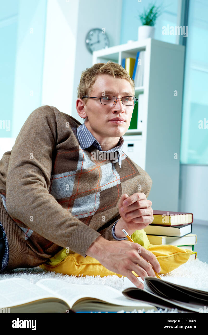 Image of serious student lying on the floor and doing homework Stock ...